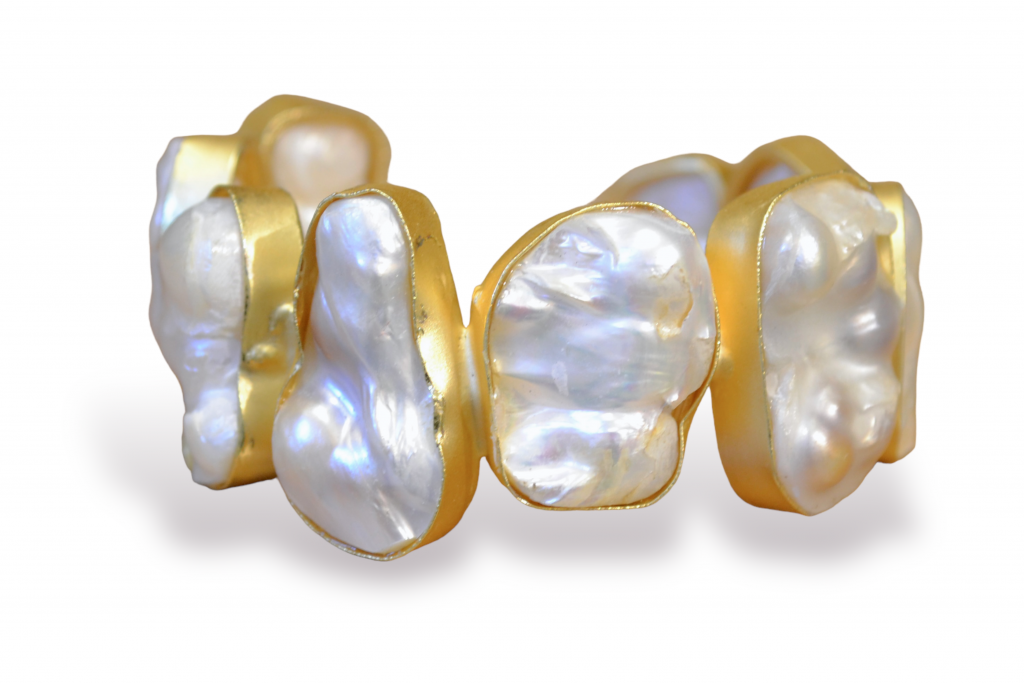 A Gold Plated Open Cuff Decorated With Nine Graduated Large White ...