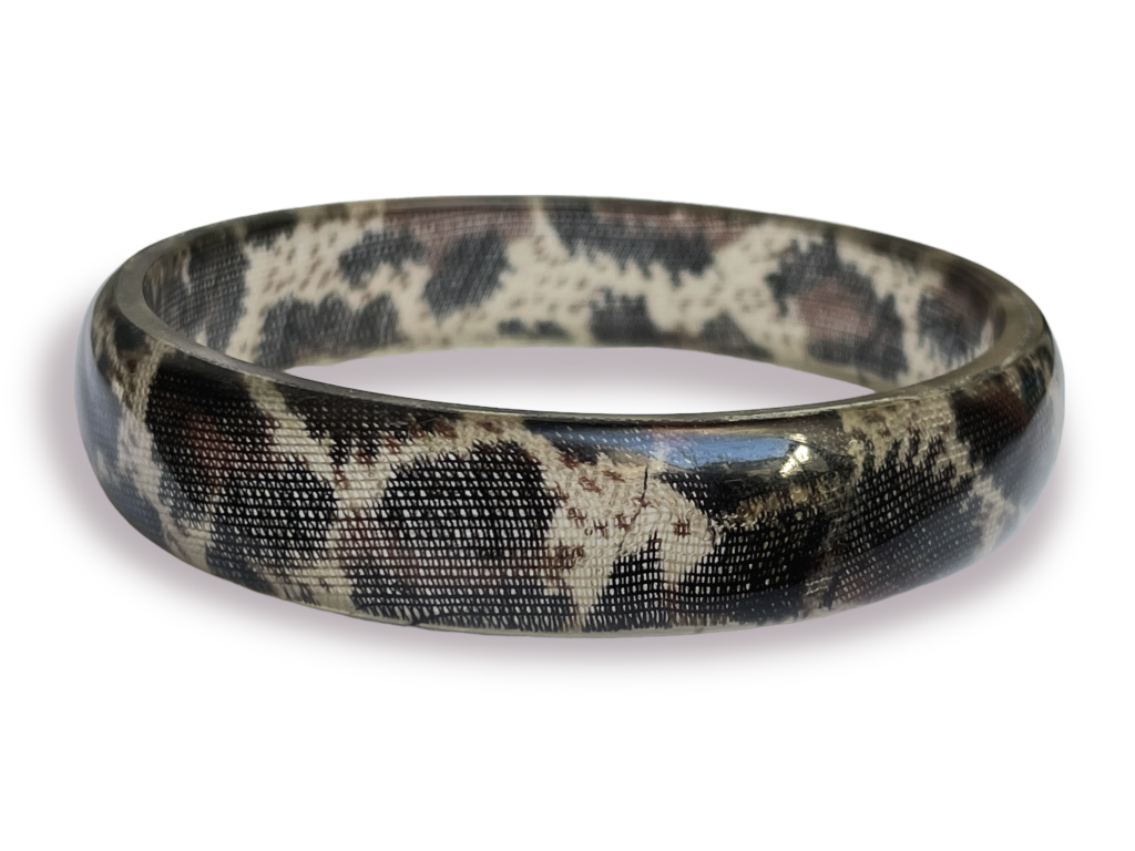 A Narrow Clear Resin Bangle Inset With A Black, Brown, And Cream ...