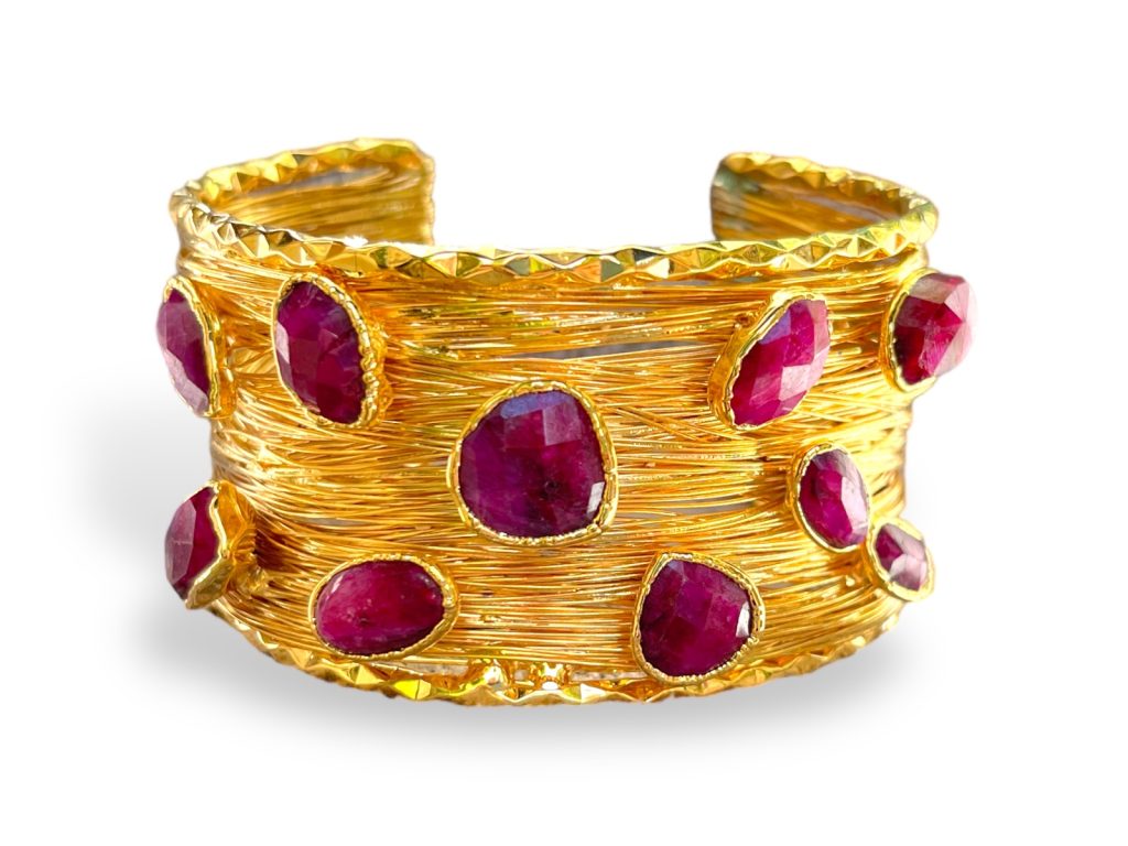 An Indian Gold Plated Wires Open Cuff With Ten Facetted Ruby Cabochons.