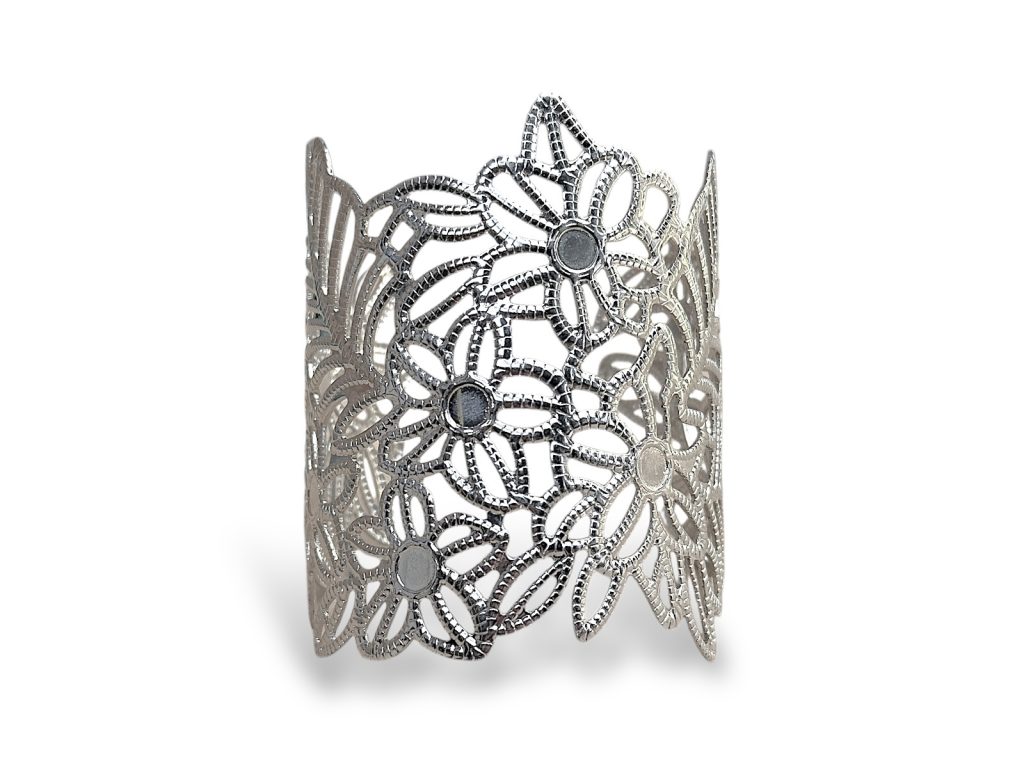 A Silvered Metal Filigree Patterned Open Cuff Of Seven Flowers And ...